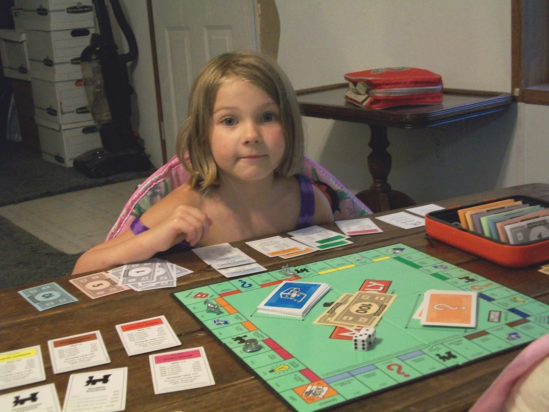 girl playing monopoly – US Represented